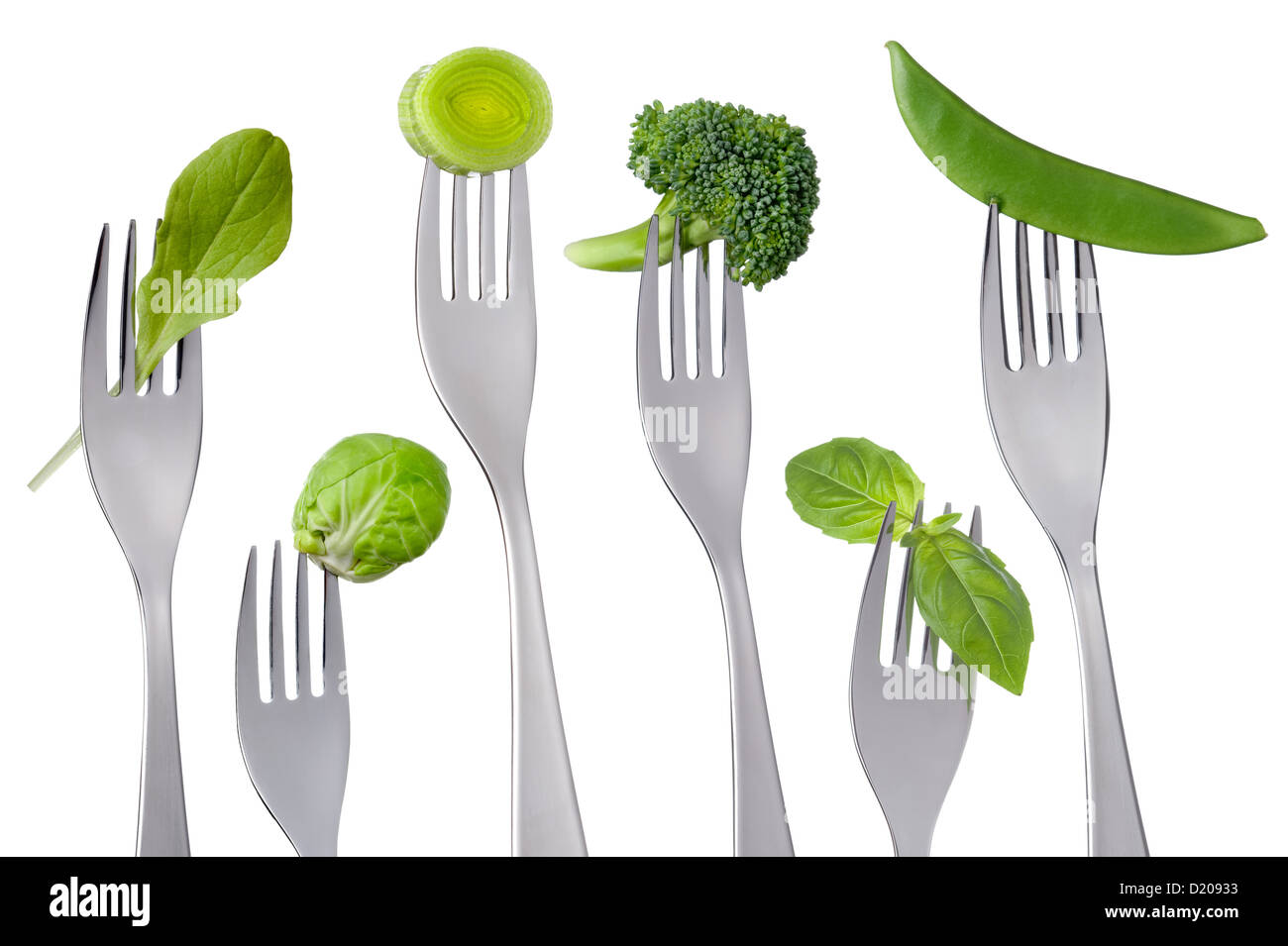 raw fresh healthy green food on forks isolated against white background ...