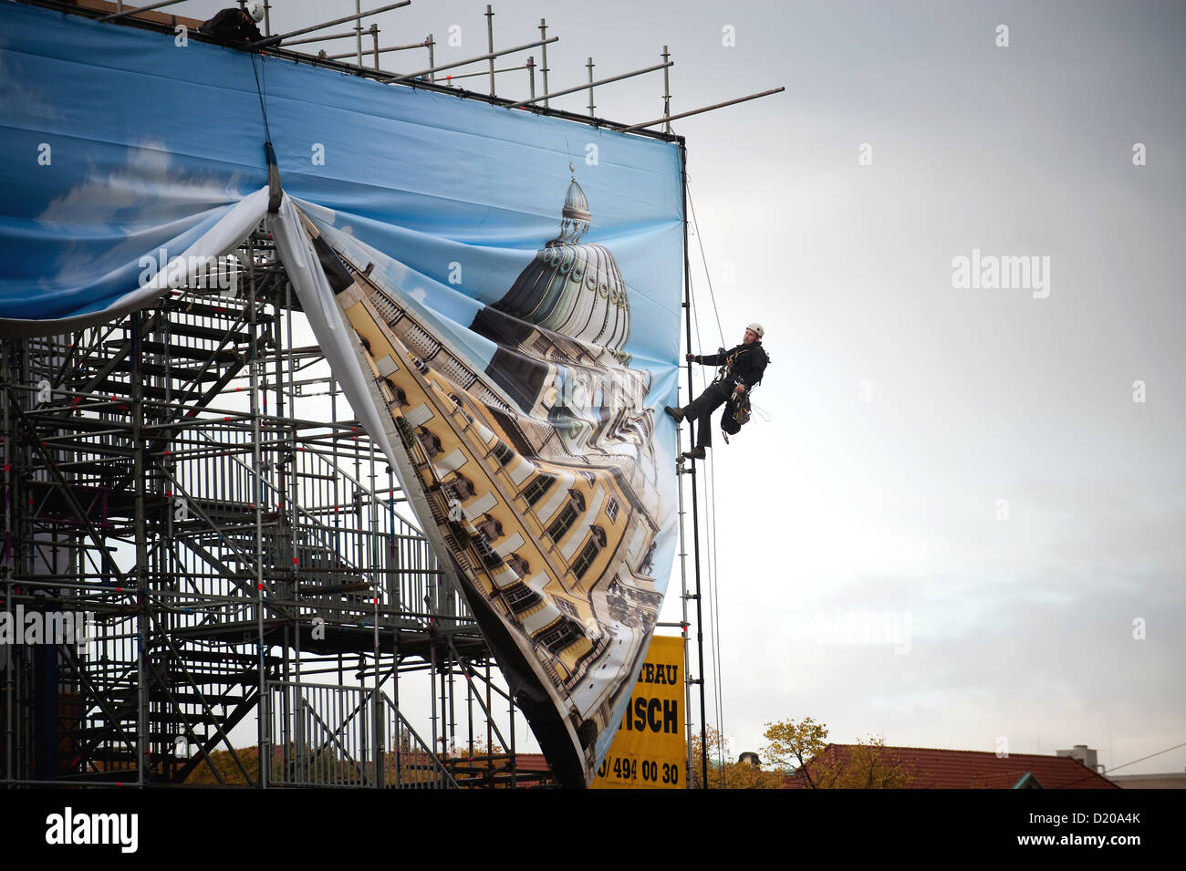Berlin, Germany, workers get a large poster from the City Palace Stock ...