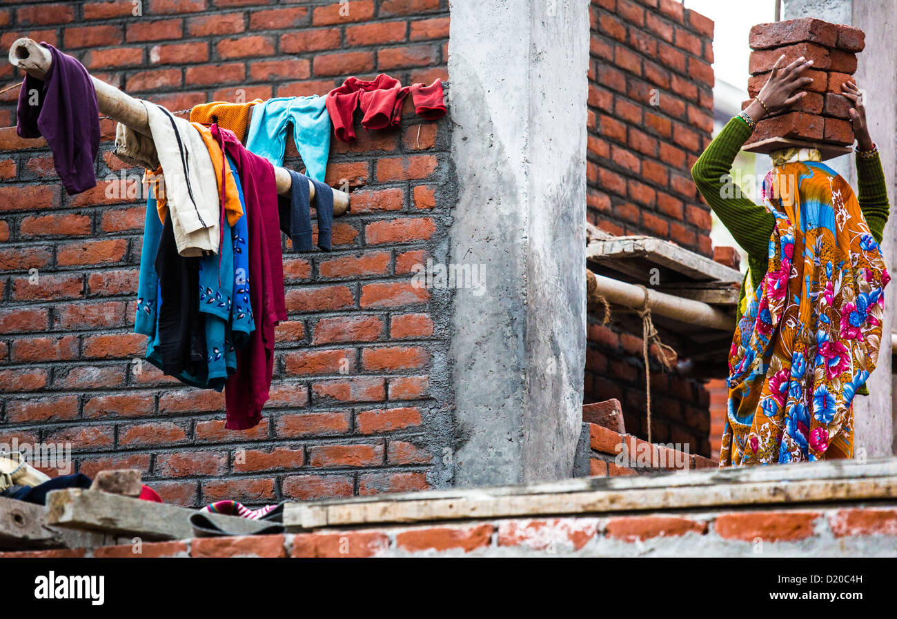 Woman lifting bricks hi-res stock photography and images - Alamy