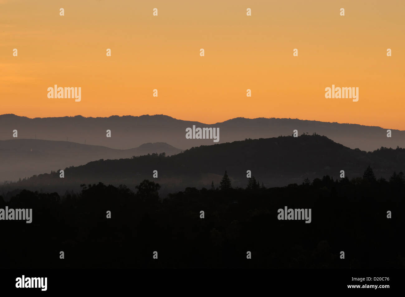 Golden sky over the distant hills at sunrise Stock Photo - Alamy