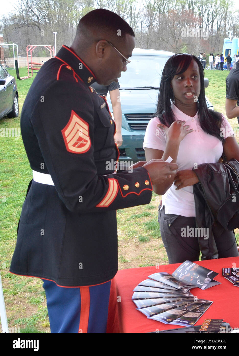 A Marine recruiter talks to a teenage girl about joining the Marines ...