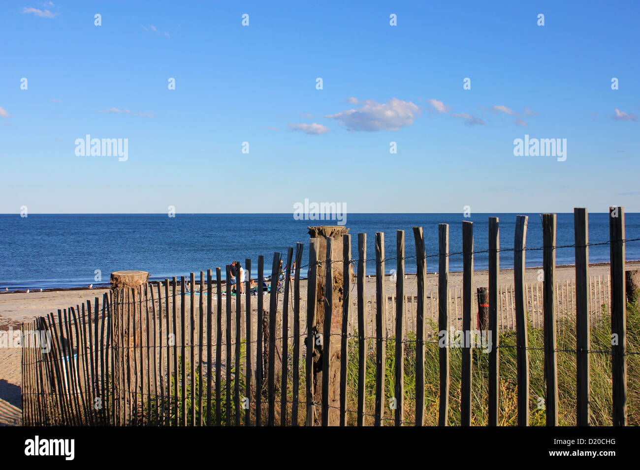 A Cape Cod New England beach lying in the afternoon sun, partly seen ...