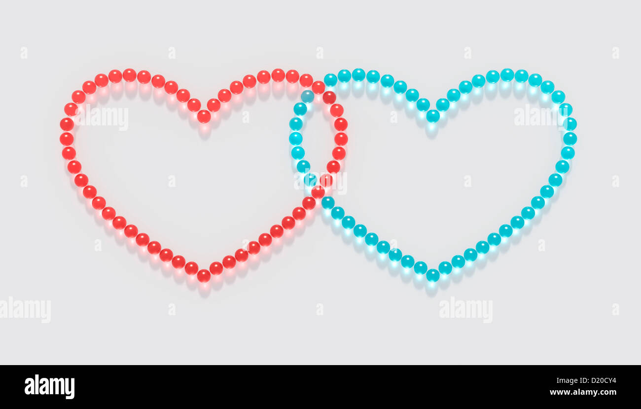 Clear, shining blue & red marbles are arranged on a white background in ...