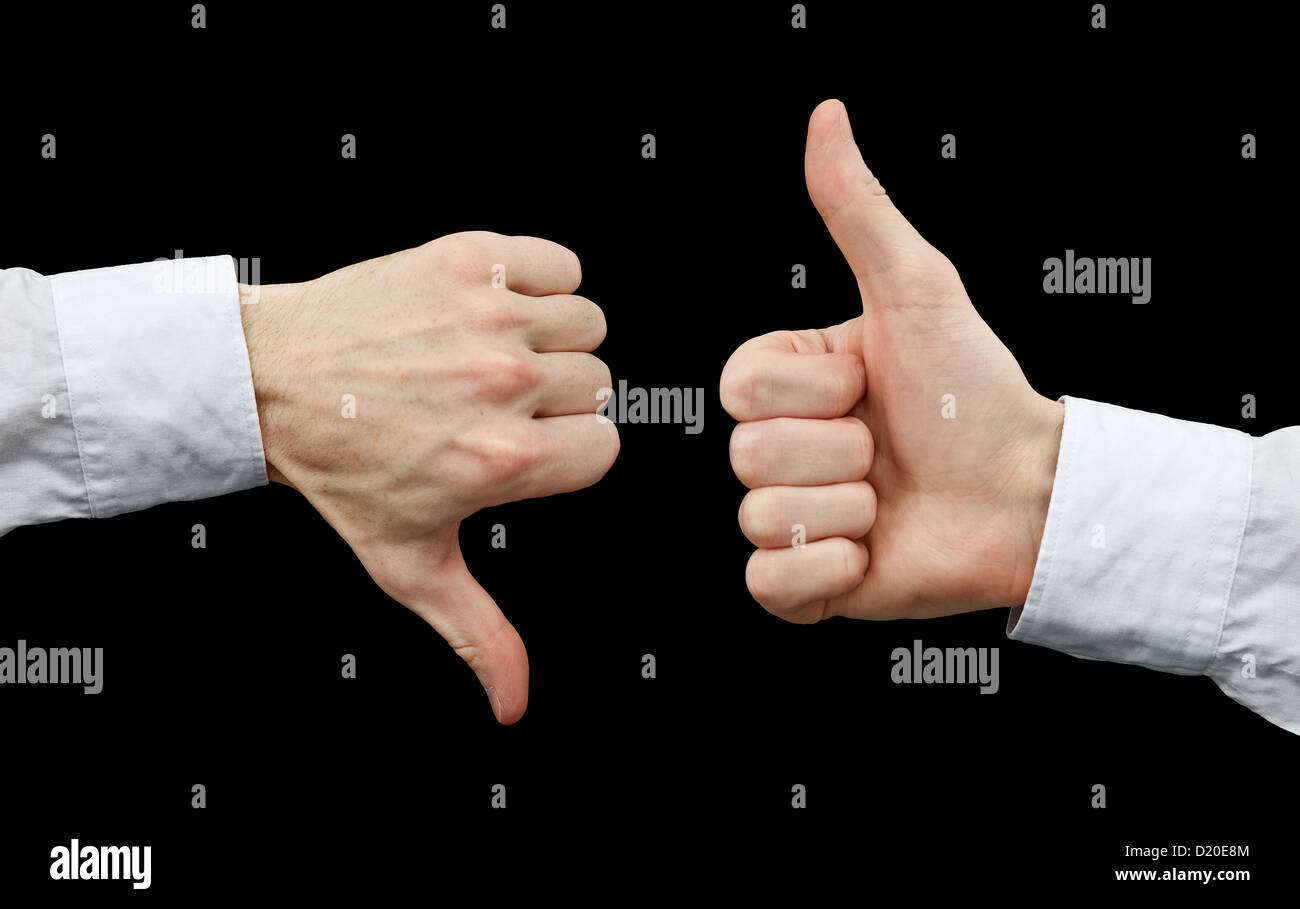 Two hands showing different gestures. Thumb up and thumb down on black ...