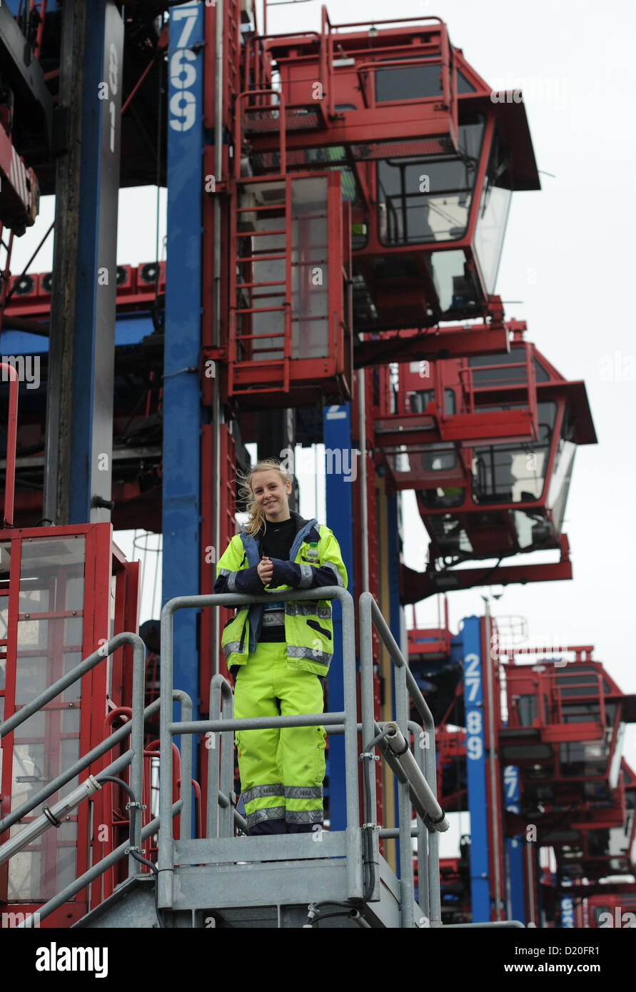 Van-carrier operator Denise Koehler stands on metal bridge leading to ...
