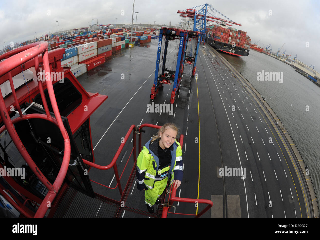 Van-carrier operator Denise Koehler stands on metal bridge leading to ...