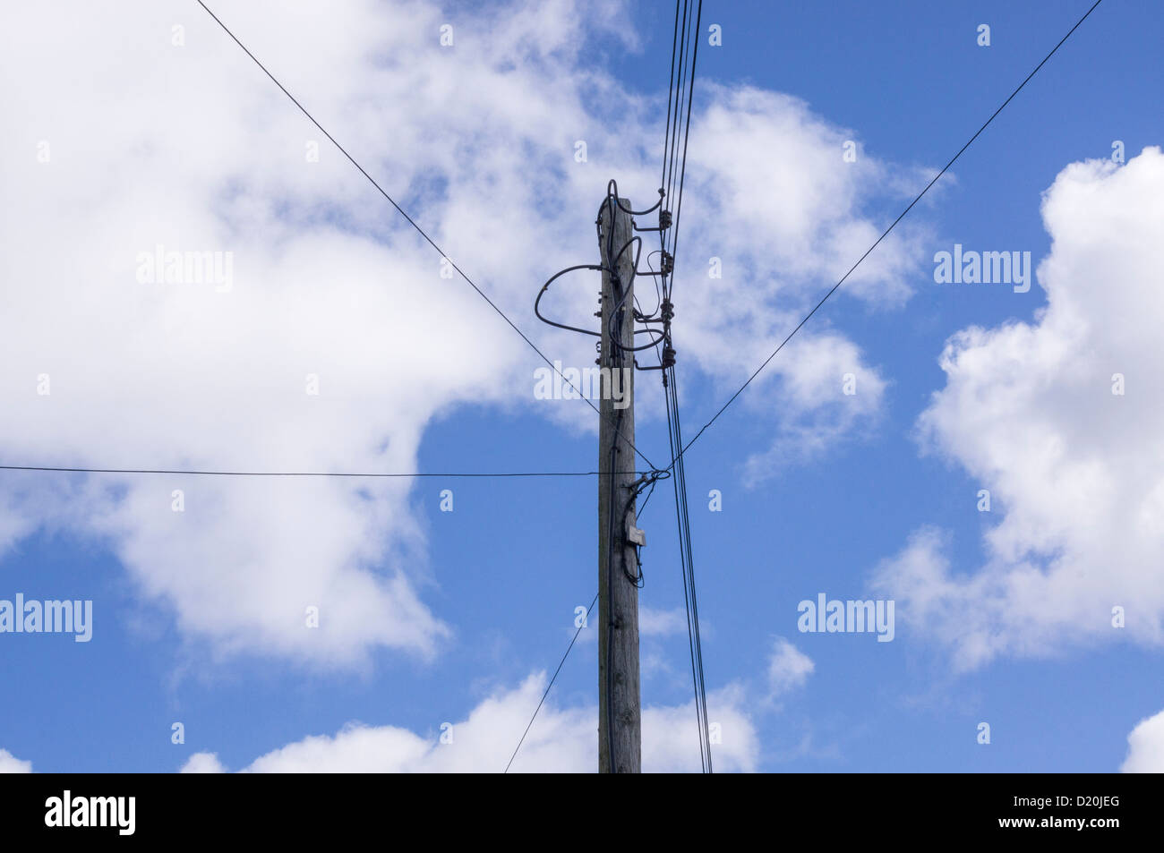 overhead Electricity cables carried on a pole in a village Stock Photo ...