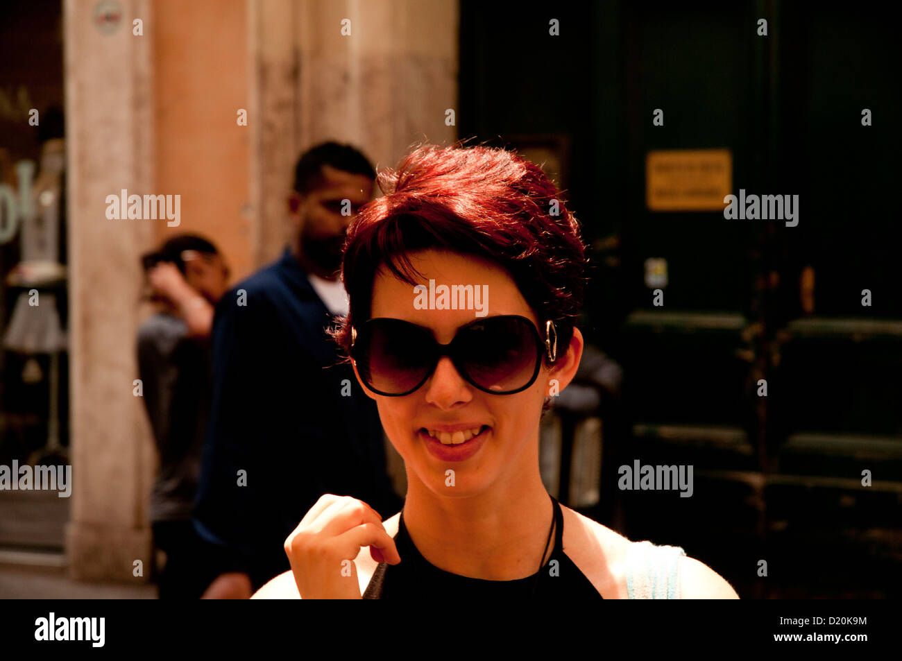 Pretty Roman woman with auburn hair wearing sunglasses Stock Photo - Alamy