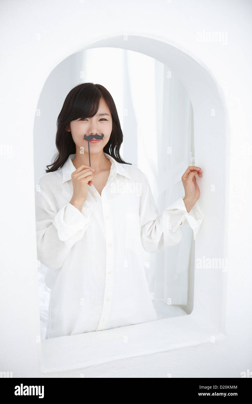 woman wearing white shirt and holding a mustache figure Stock Photo - Alamy