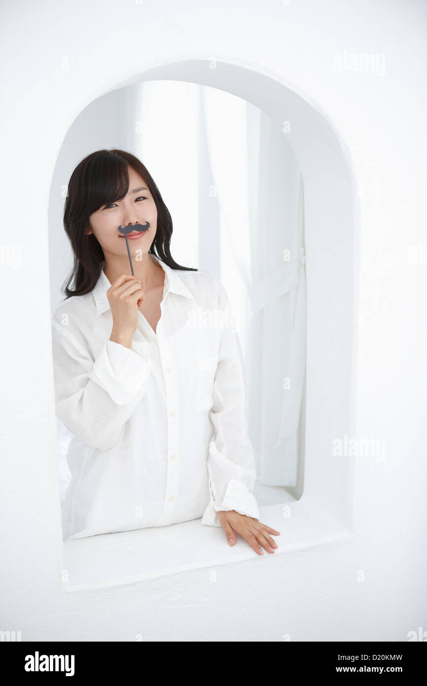 woman wearing white shirt and holding a mustache figure Stock Photo - Alamy