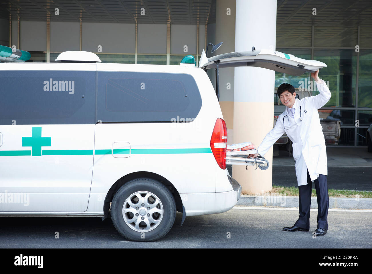 doctor putting a carrier in the ambulance Stock Photo - Alamy