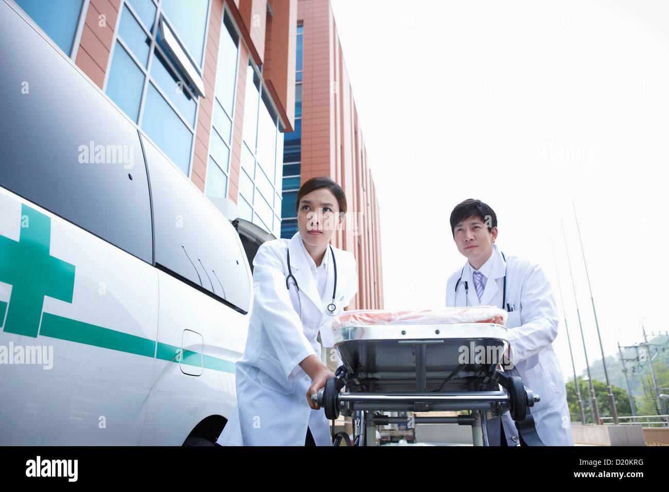 doctors moving a carrier ungently into the hospital Stock Photo - Alamy
