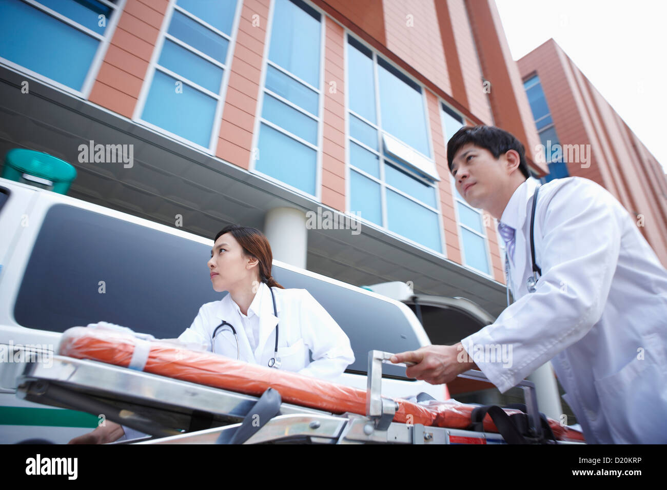 doctors moving a carrier ungently into the hospital Stock Photo - Alamy
