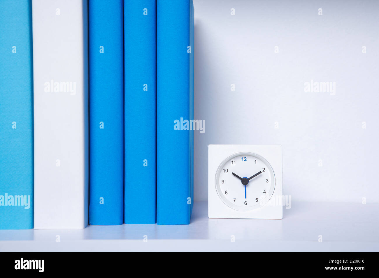 books and a clock on the book shelf Stock Photo - Alamy