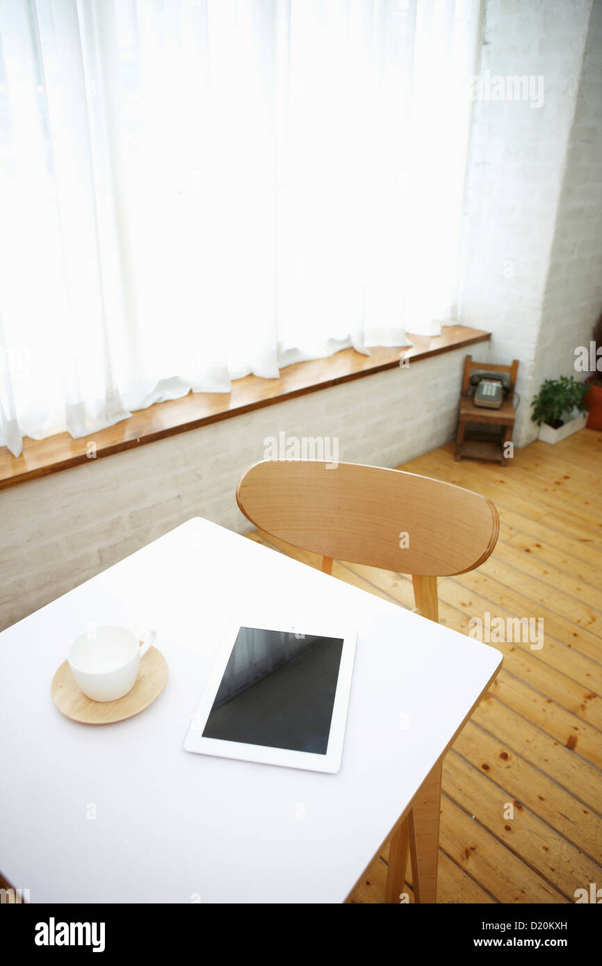 a cup of coffee and digital tablet on the table Stock Photo - Alamy