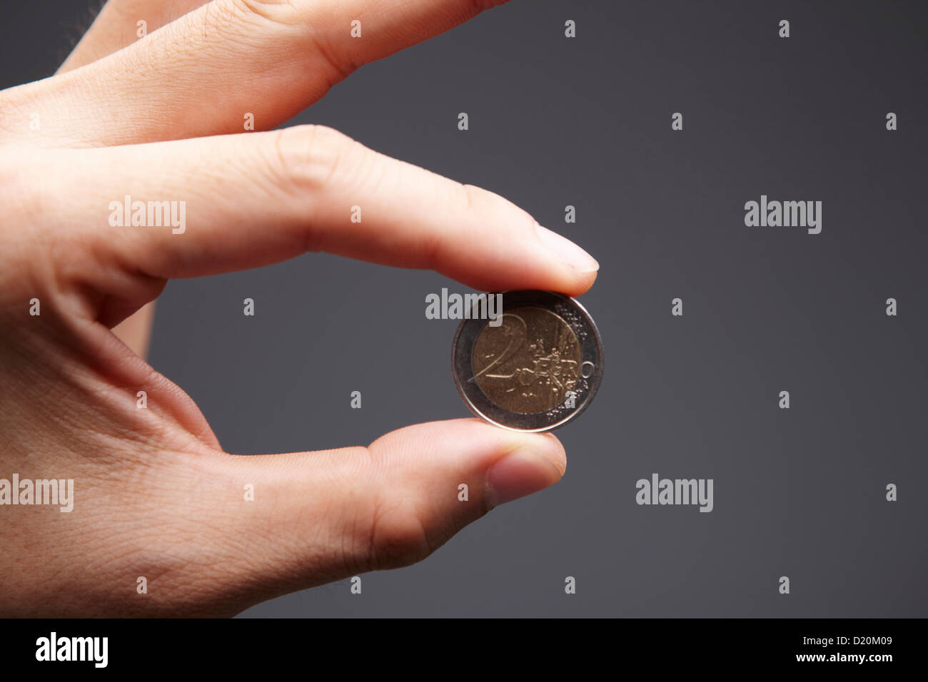 coin held by fingers Stock Photo - Alamy