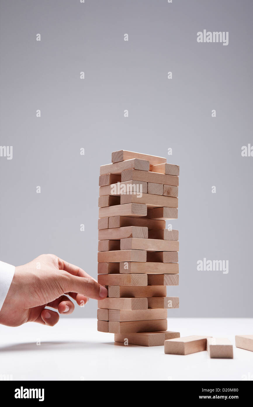 man playing Jenga Stock Photo - Alamy