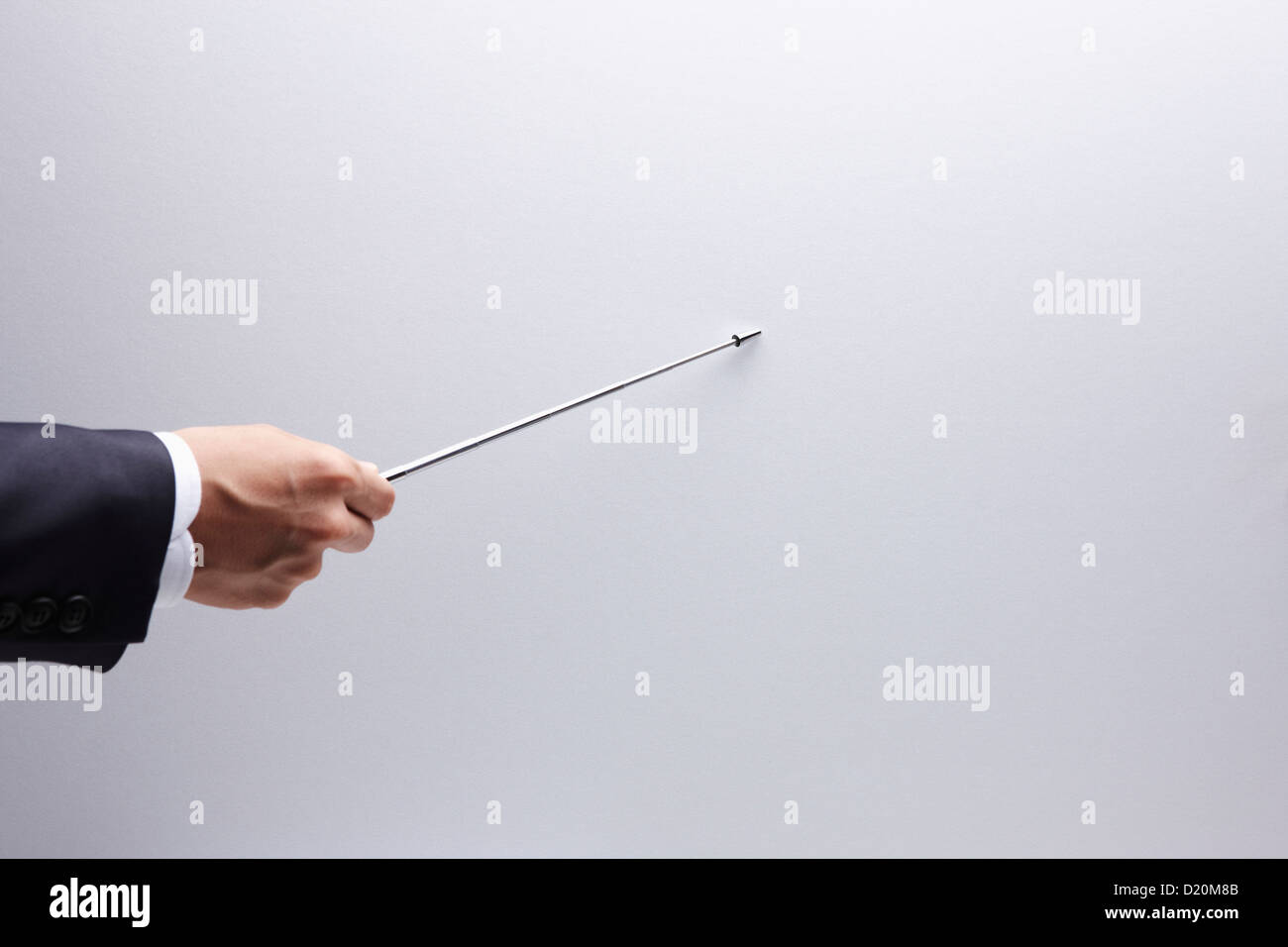 man pointing out the wall with stick Stock Photo - Alamy