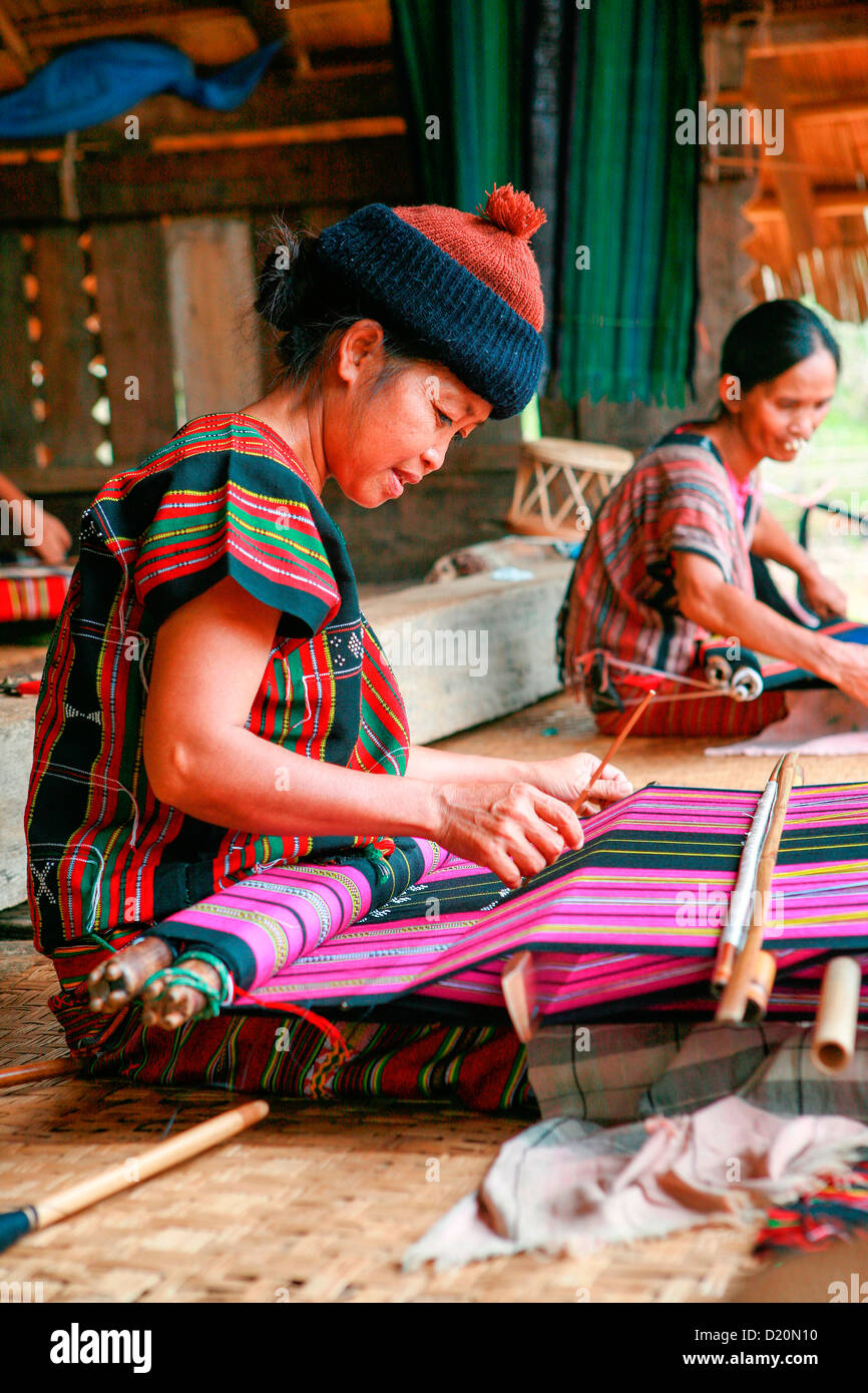 Katu tribeswomen weaving at a traditional village on the Bolaven ...
