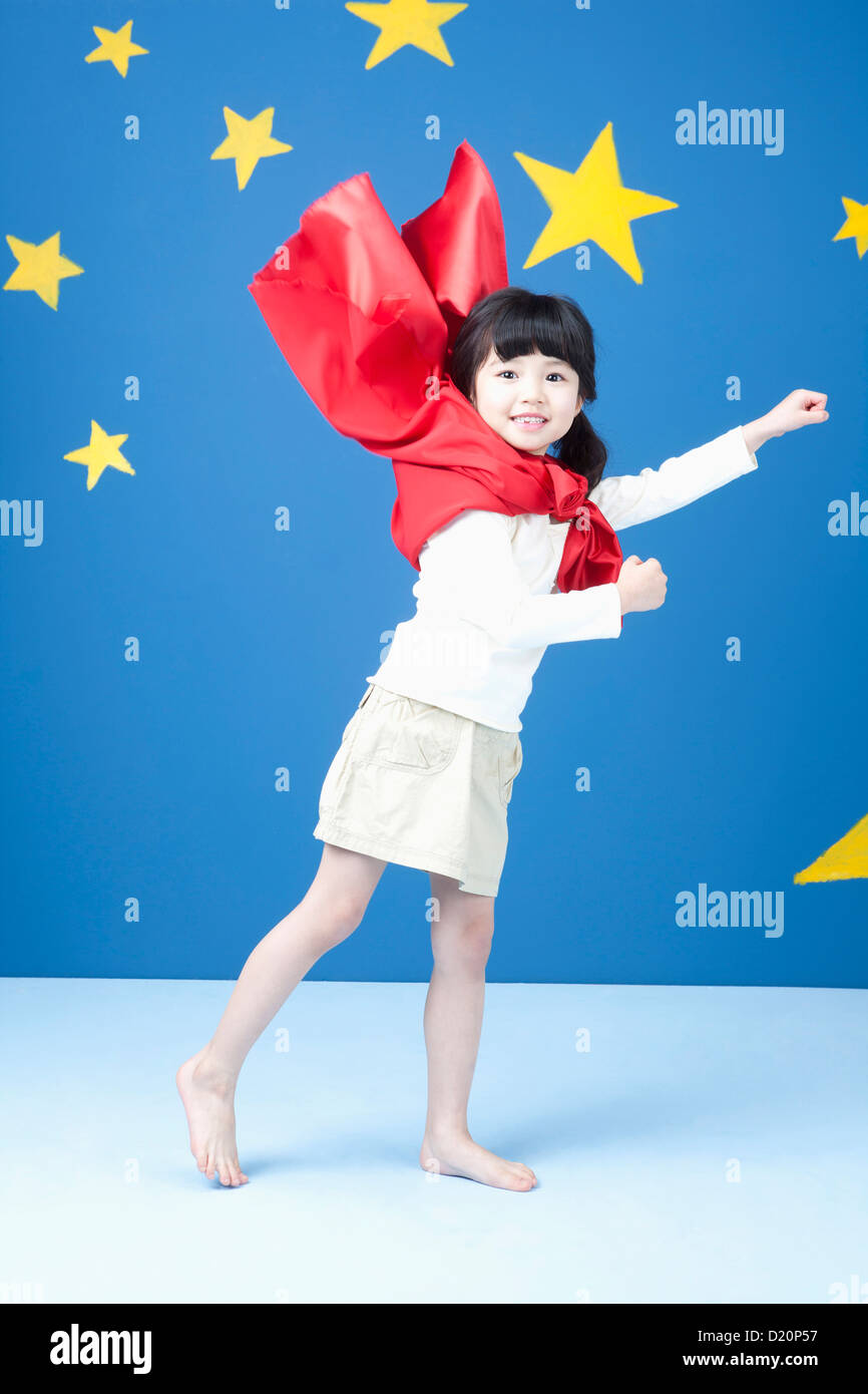 a girl spreading her arm like a superman with fluttering red cape Stock ...
