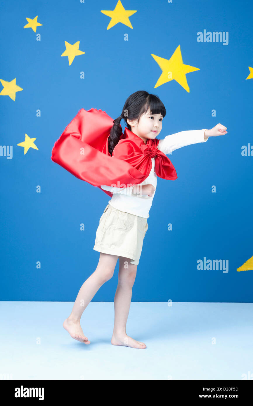 a girl spreading her arm like a superman with fluttering red cape Stock ...