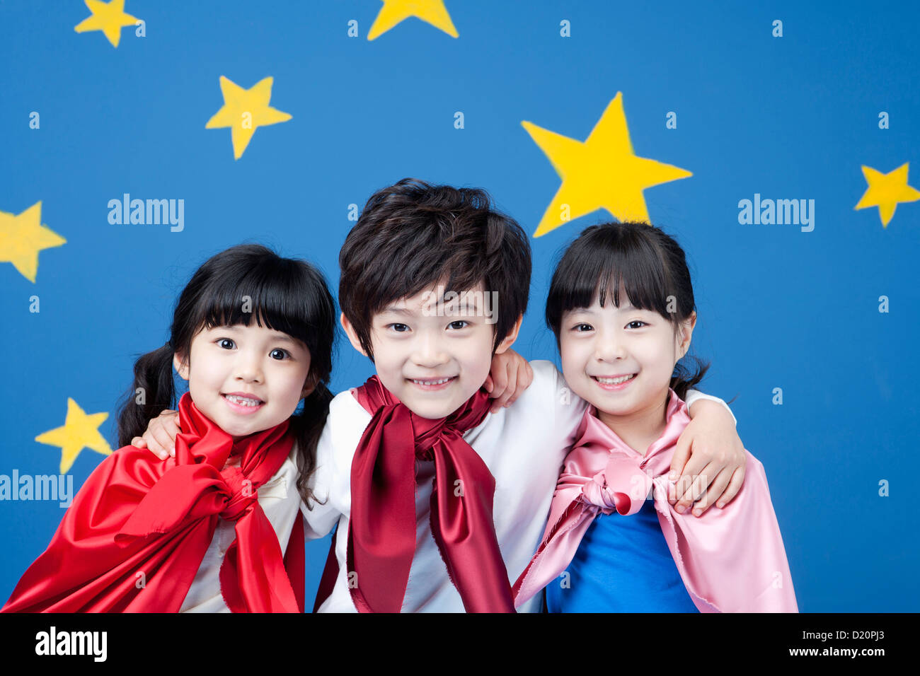 kids wearing superman capes posing with arms around each other Stock ...