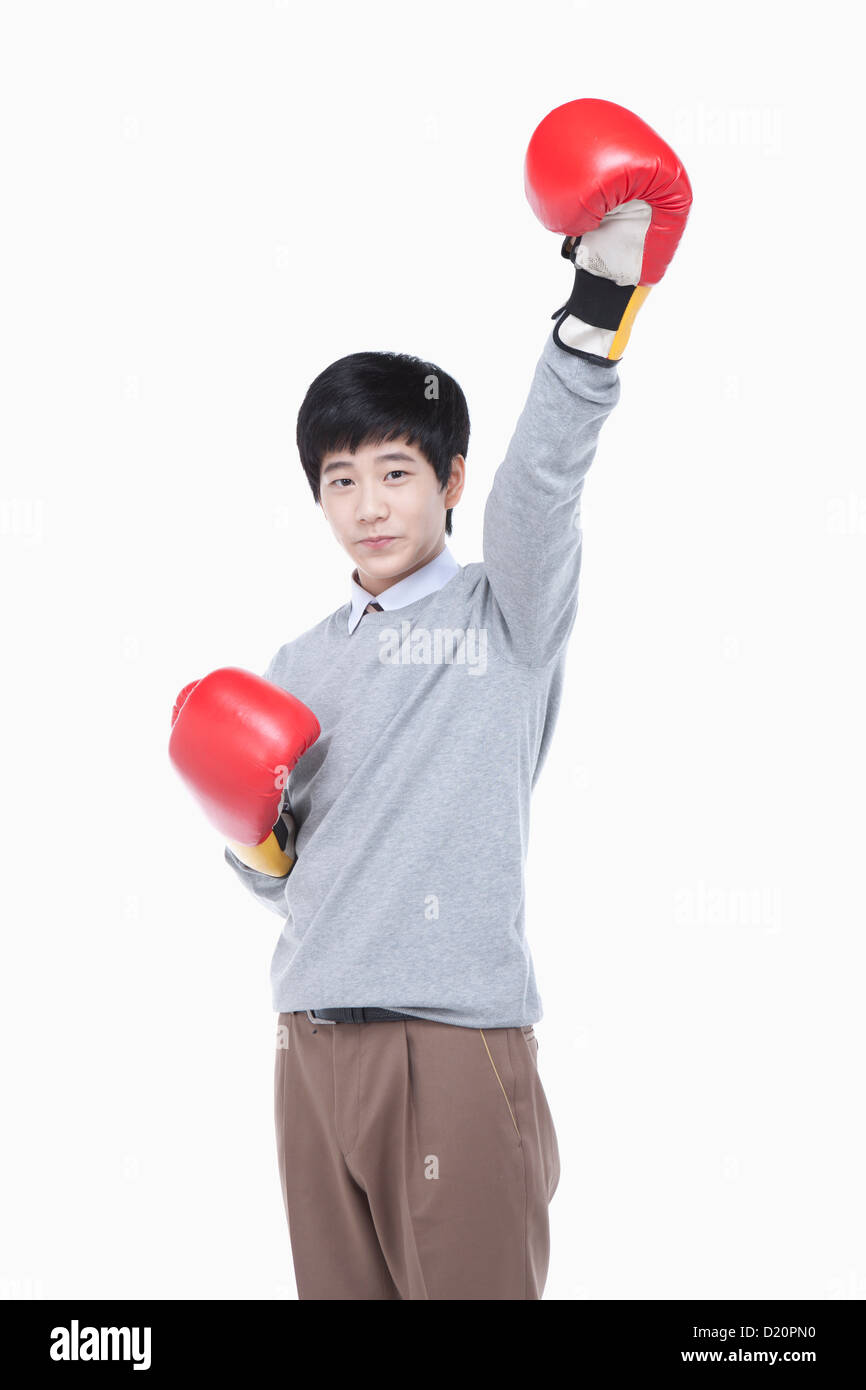 a male student with boxing gloves raising his arm up Stock Photo - Alamy
