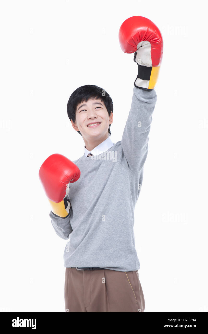 a male student with boxing gloves raising his arm up Stock Photo - Alamy
