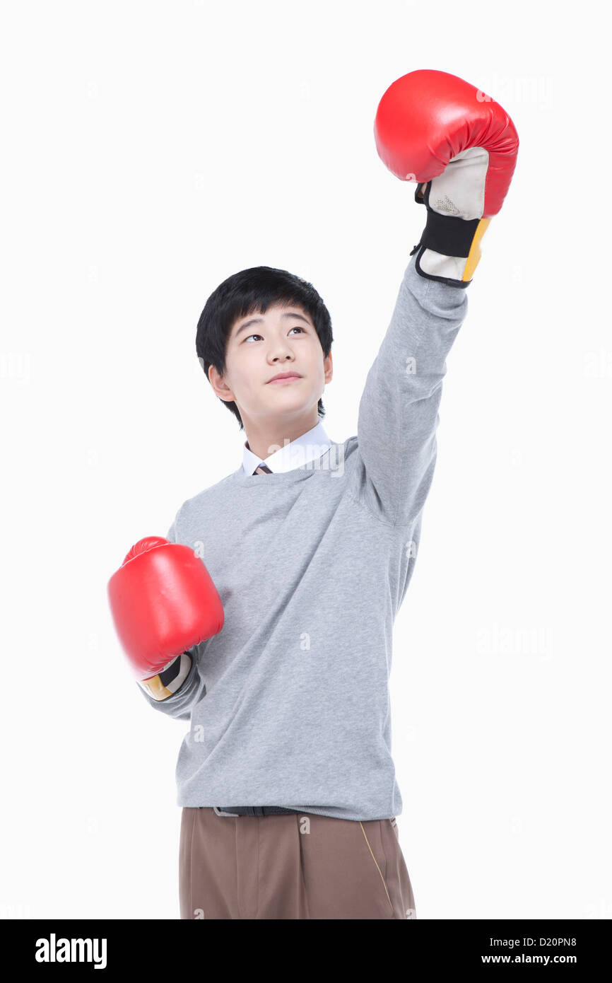 a male student with boxing gloves raising his arm up Stock Photo - Alamy