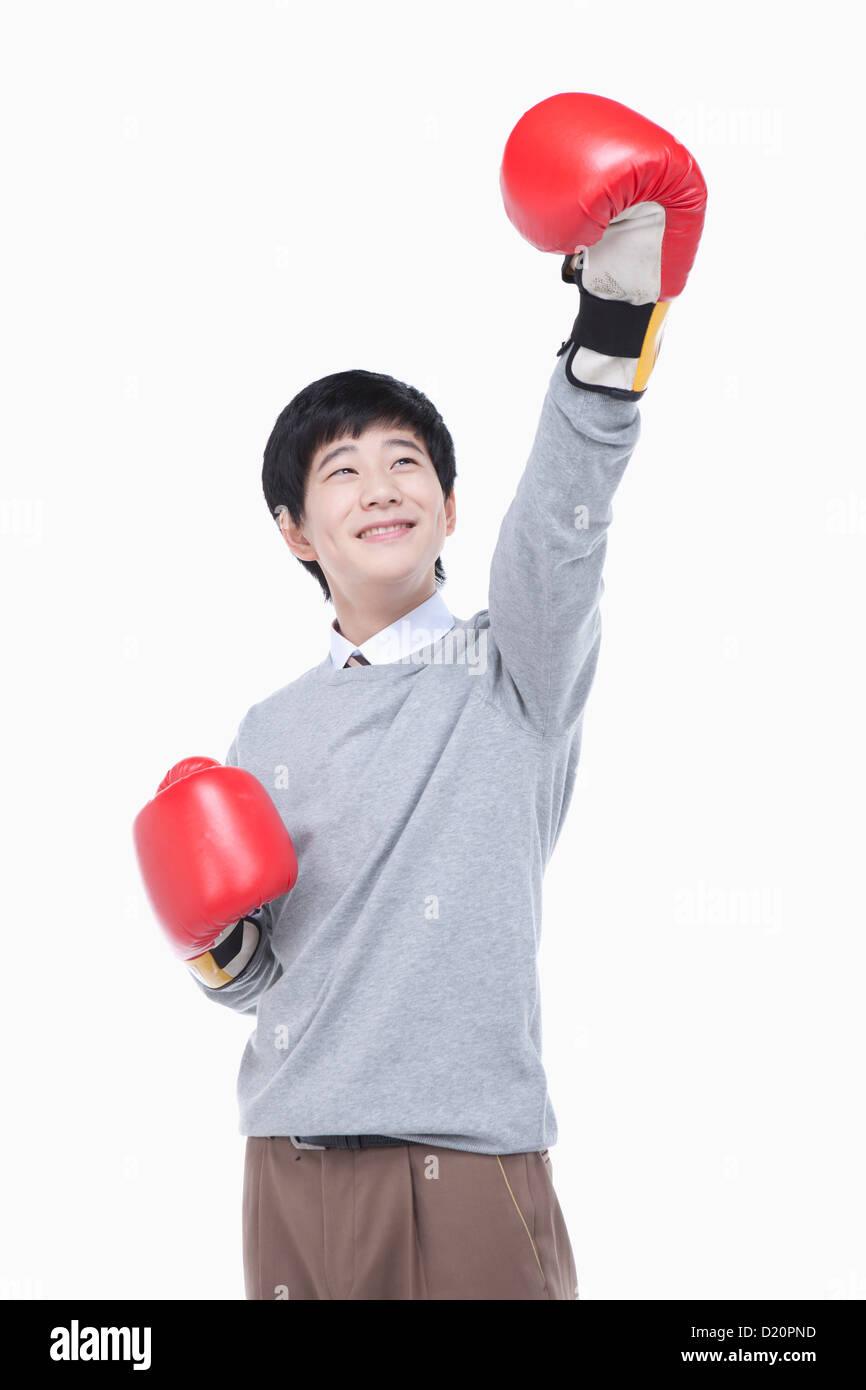 a male student with boxing gloves raising his arm up Stock Photo - Alamy