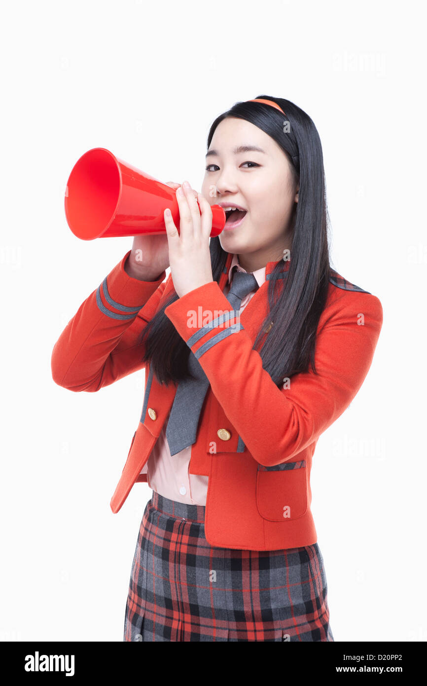 a female student speaking through a red megaphone Stock Photo - Alamy