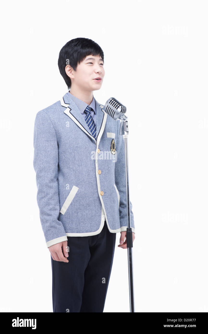 a male student making a speech through a microphone Stock Photo - Alamy