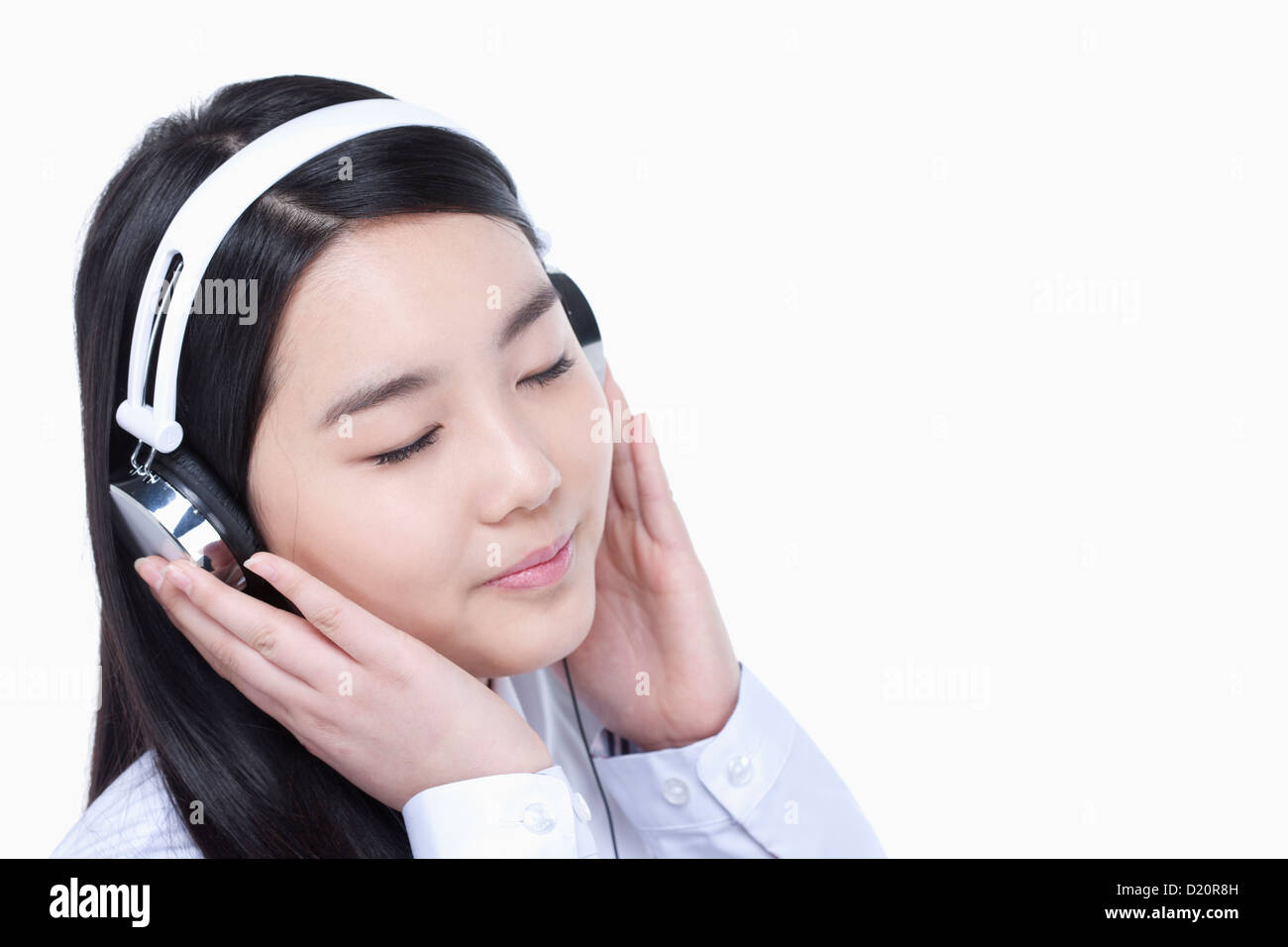 a female student listening on a headphone Stock Photo - Alamy