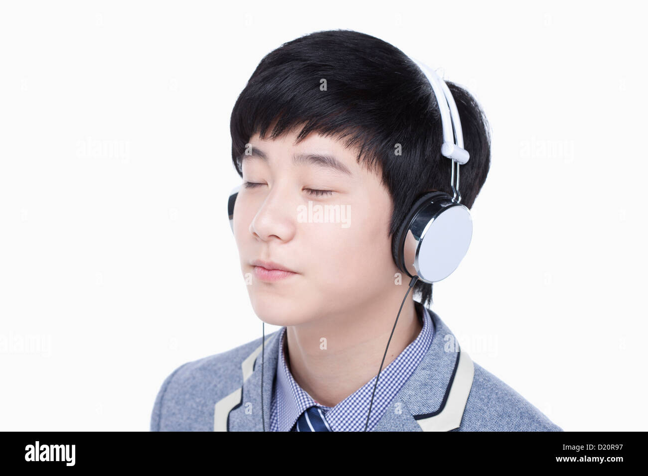 a male student listening on a headphone Stock Photo - Alamy