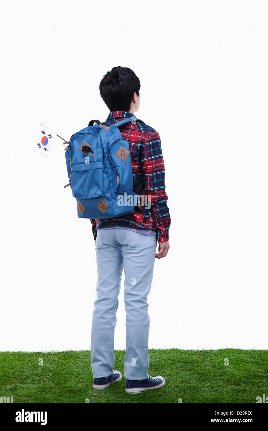 a man standing wearing a backpack Stock Photo - Alamy