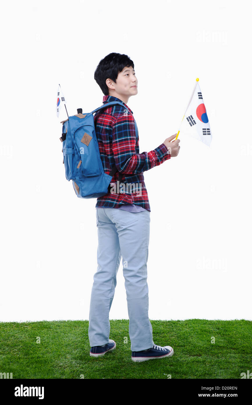 a man with a backpack holding a Korean flag Stock Photo - Alamy