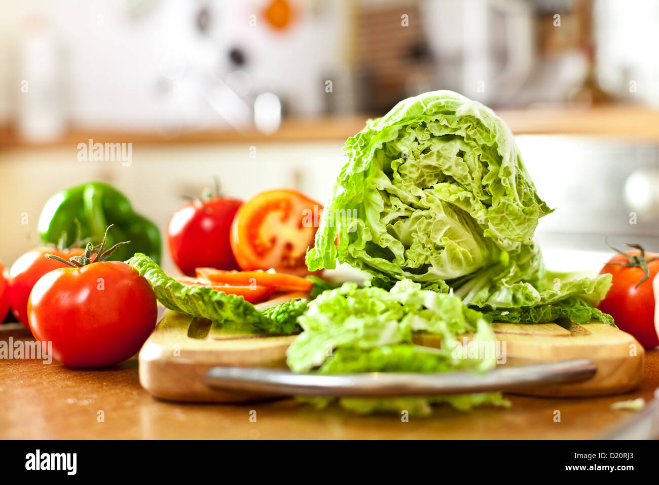 Vegetables lay on a table against kitchen Stock Photo - Alamy