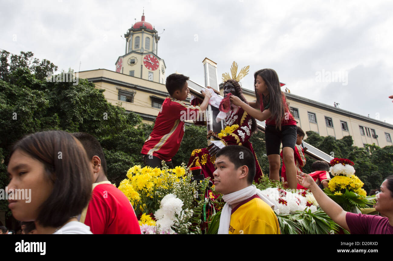 Thousands of Catholic devotees join the procession of the life-size ...