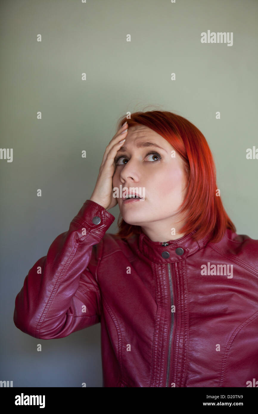 woman with hand on forehead Stock Photo - Alamy