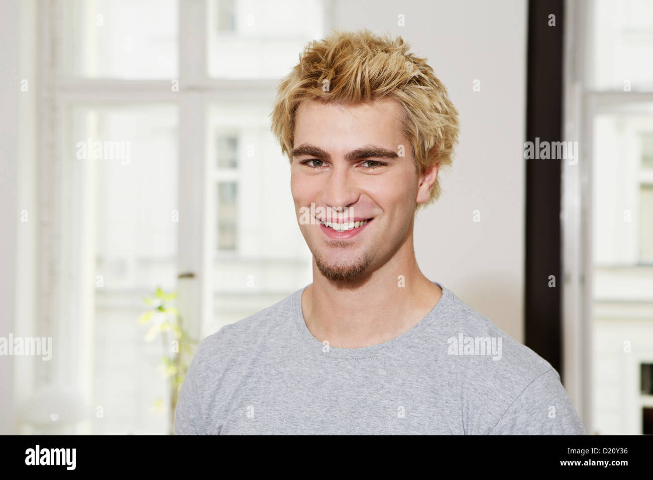 Germany, Berlin, Young man smiling, portrait Stock Photo - Alamy