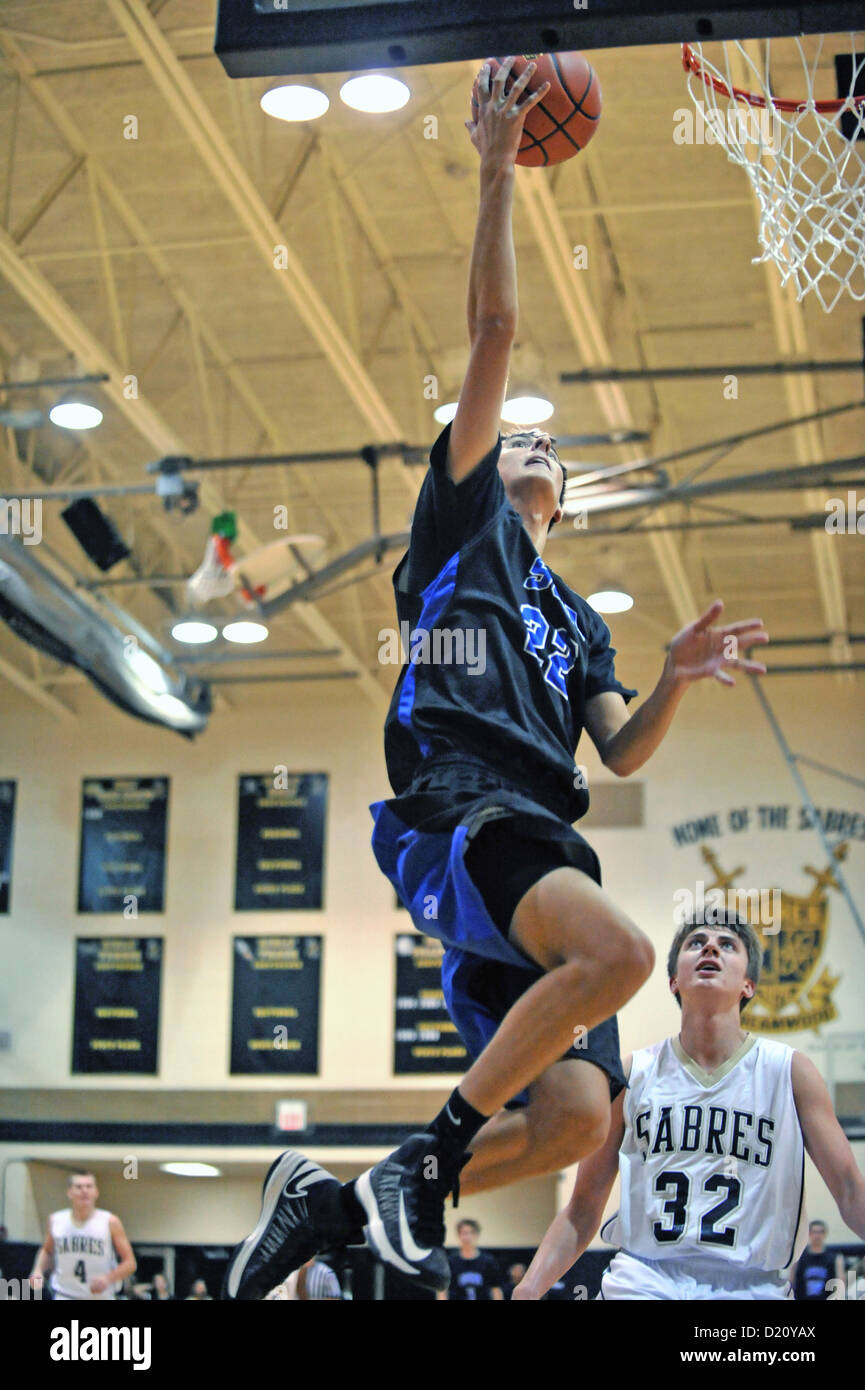 Sport Basketball male Player elevates his game to lay in two points ...