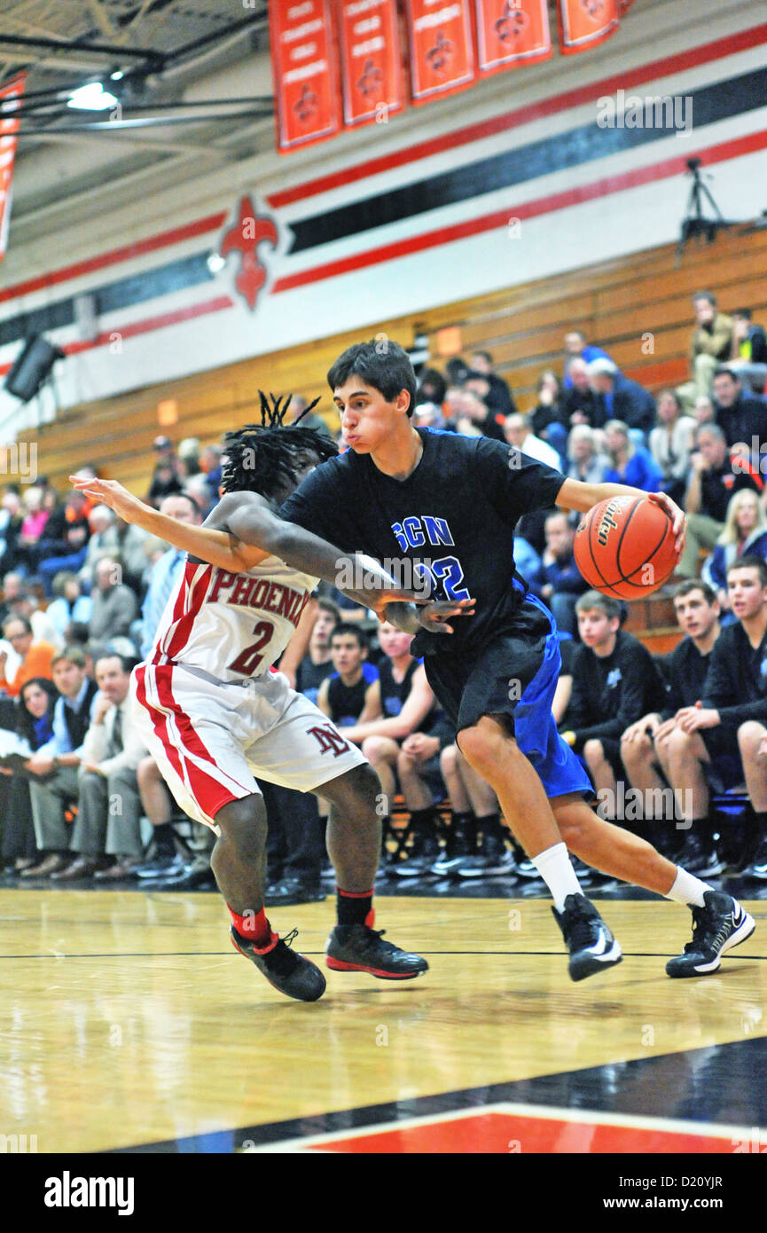 Sport Basketball male defender reaches in an effort to restrain his ...