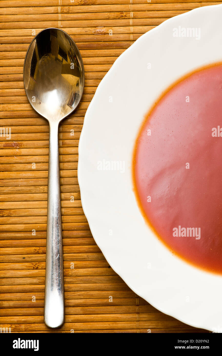 tomato soup and a spoon. half of the plate. view from the top Stock ...