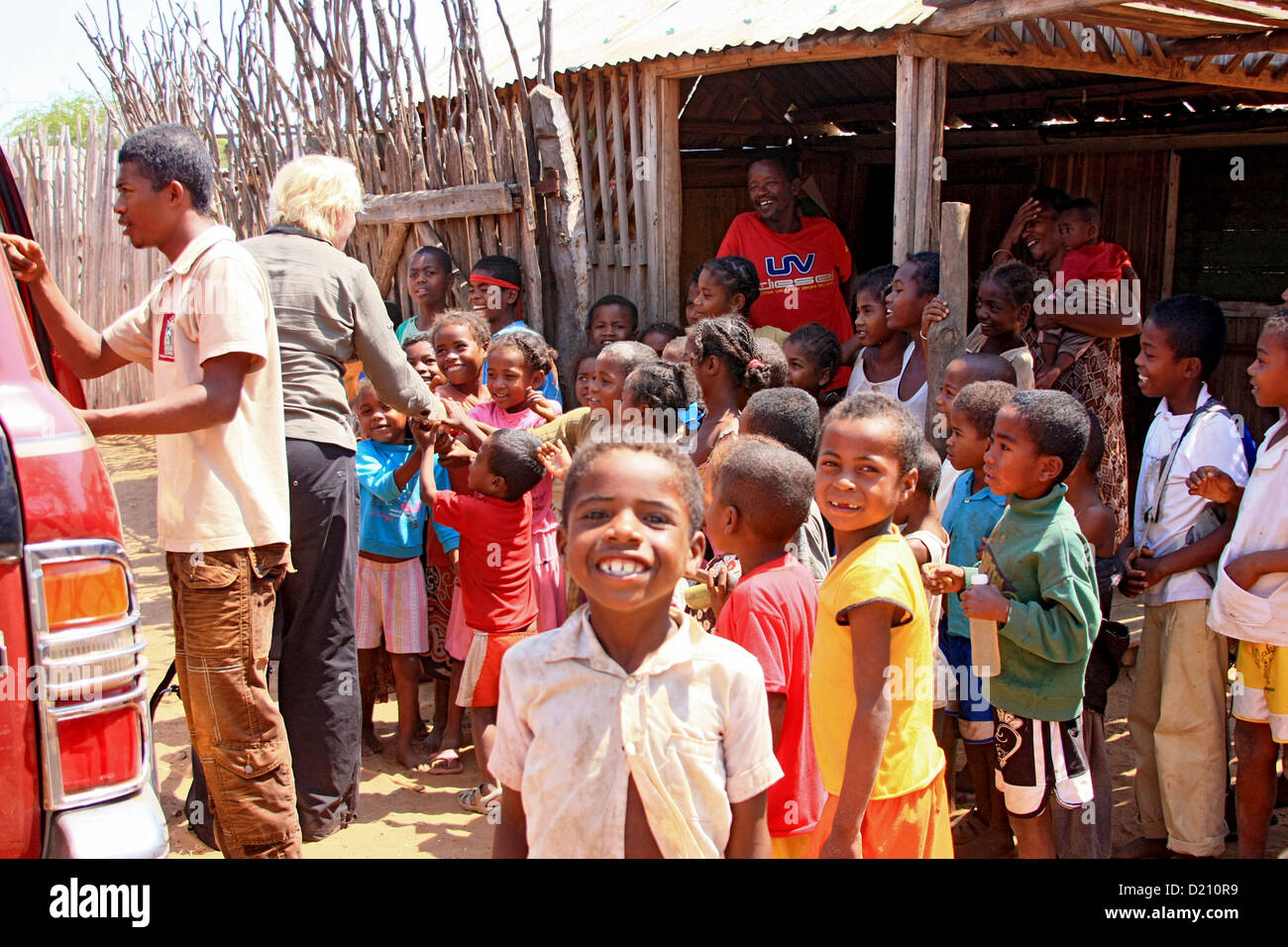 A tourist with Malagasy children from a village in the Ifotaka ...