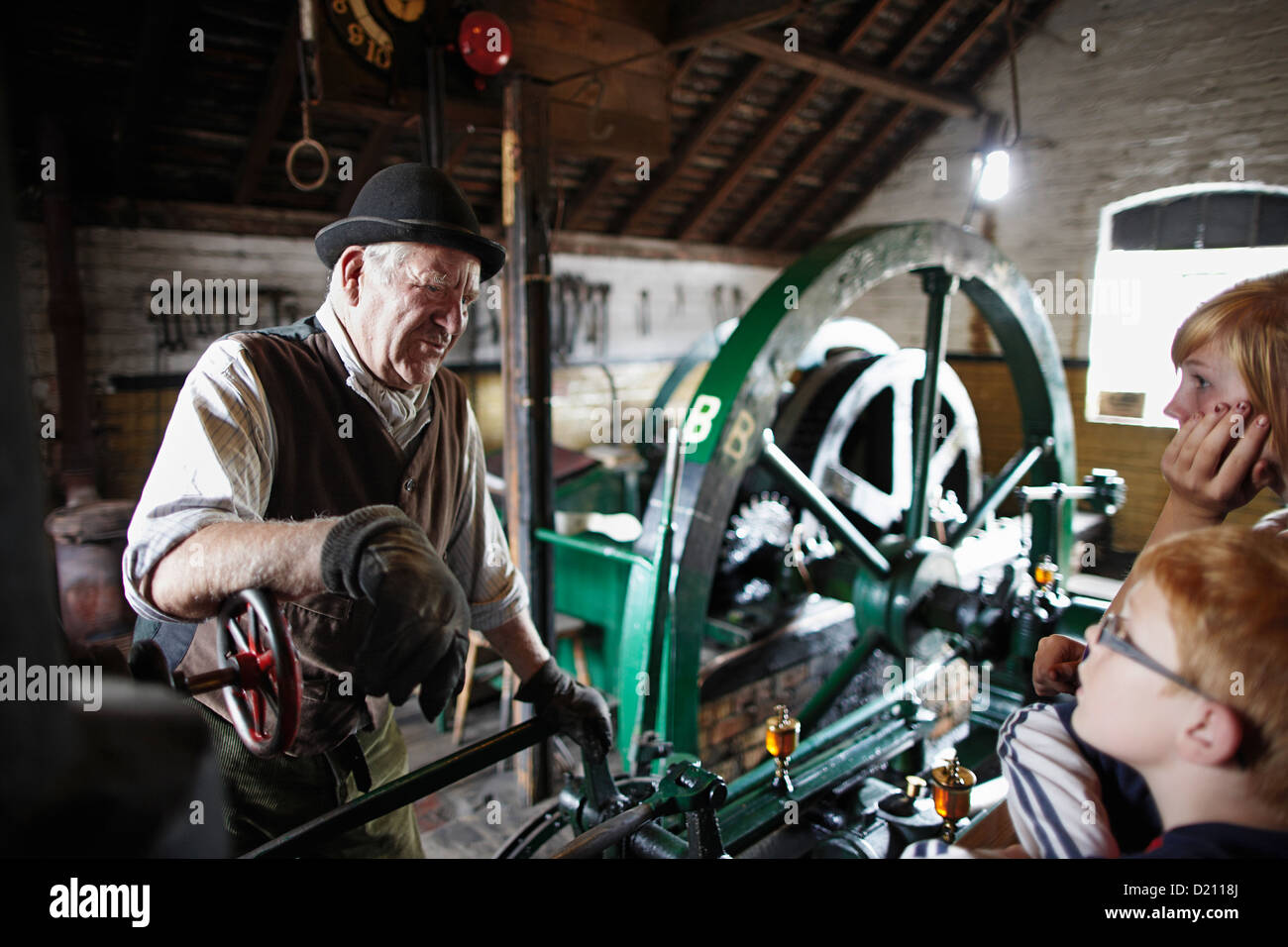 Volunteer explains steampowered flywheel to visitors, The Iron Gorge ...