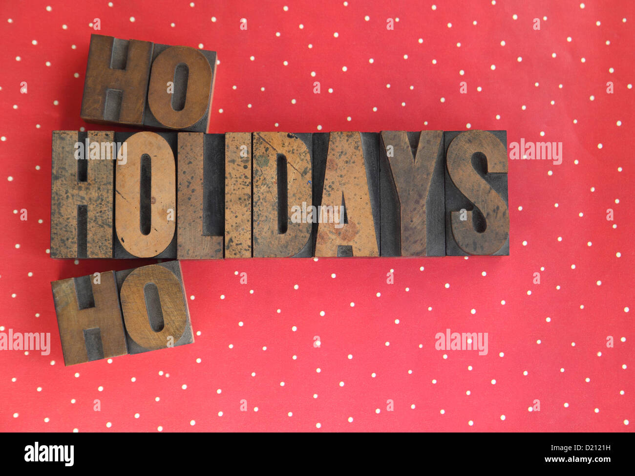 holidays ho ho words in old wood type on a polka dot background Stock ...
