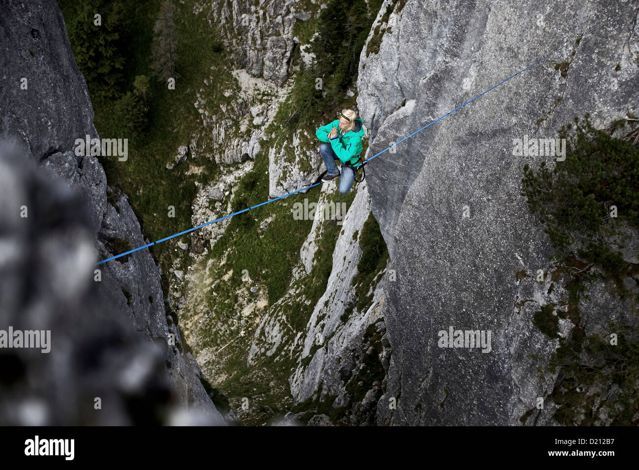 Young man balancing on a highline between two rocks, Oberammergau ...