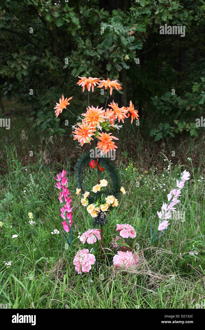 Gomel, Belarus, a cross with flowers on the roadside does a traffic ...