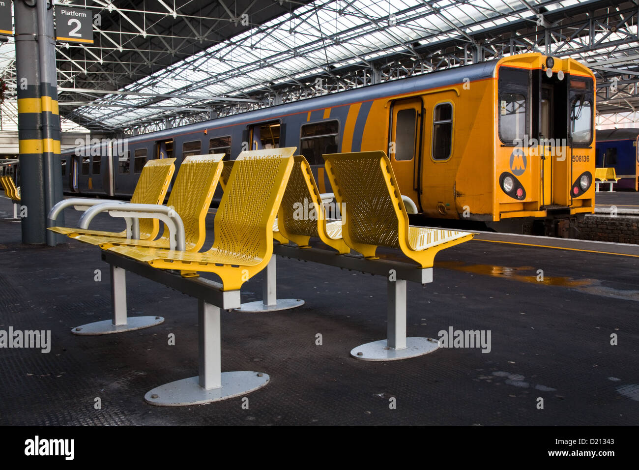 Northern Line Merseyrail network, platform seating and train in station ...