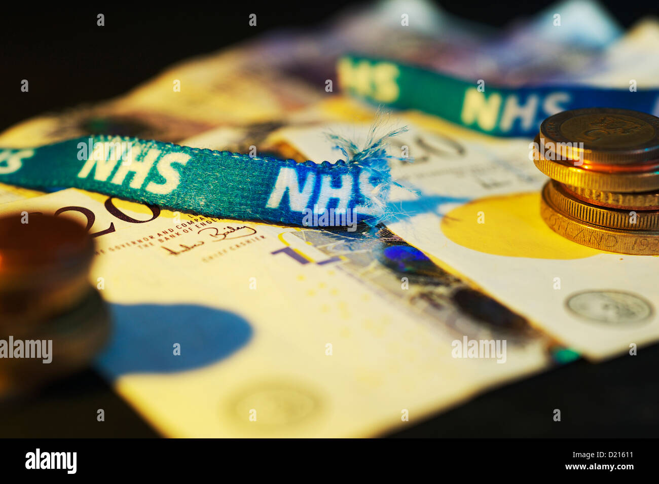 NHS neck ribbon snapped in half and fraying. laying on a bed of money ...